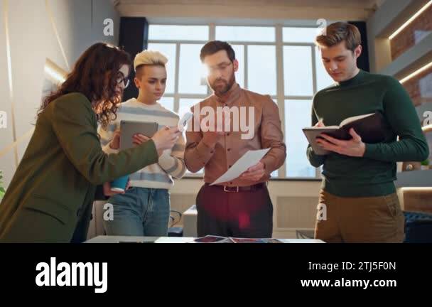 Young team creating ideas at office brainstorm standing modern boardroom. Professional ...