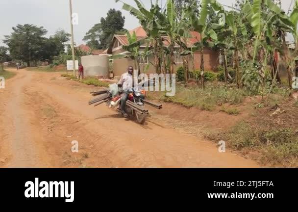 Black man driving a bike carrying too many staff, heavy loaded African ...