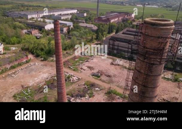 Old brick thick pipe on empty plant. Abandoned factory with many ruined ...