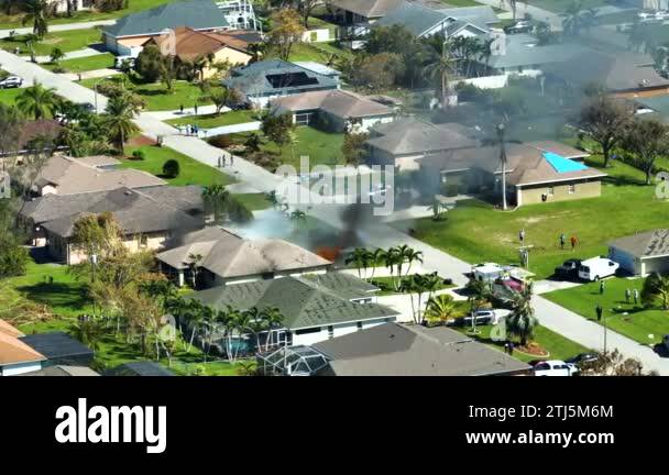 Burning residential house on fire with smoke and flames and ...