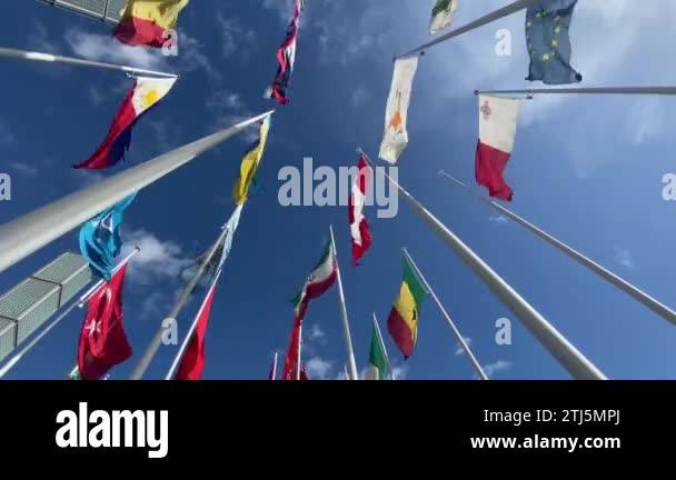 Flags of the World waving in the wind on a background blue sky and ...
