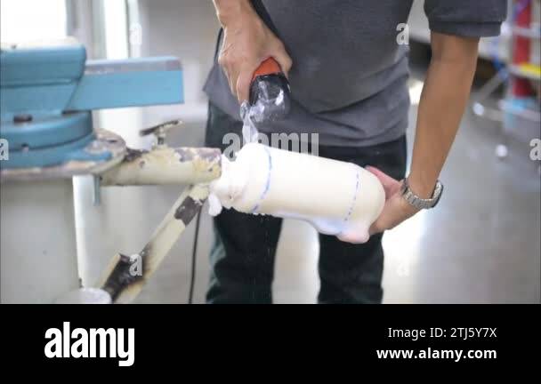 Prosthetic technician sculpting plaster cast for socket at prosthetic production factory, High ...