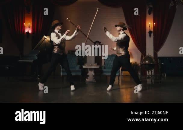 Two stylish professional male dancers in classy dandy hat performing ...