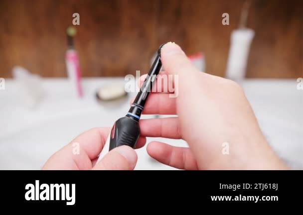 Replacing worn out bristles of electric toothbrush. View of old ...