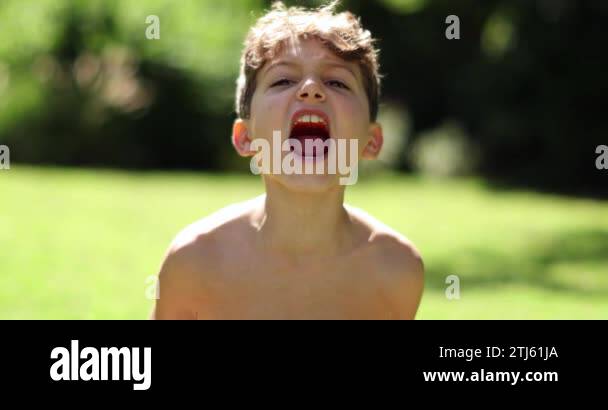 Child boy screaming from top of his lungs in slow-motion. Angry kid ...