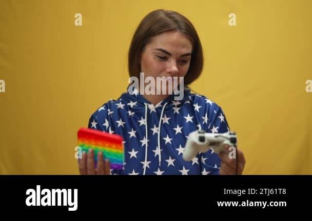 Brunette beautiful woman choosing between fidget toy and joystick in ...