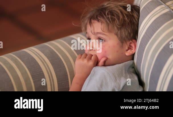 Candid little boy child hypnotized by TV screen at night on sofa Stock ...