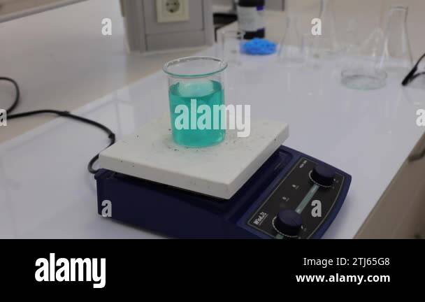 Mixing colored solution with a magnetic stirrer. Formation of a ...