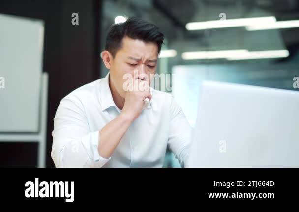Sick asian businessman coughing in office workplace. Employee ...