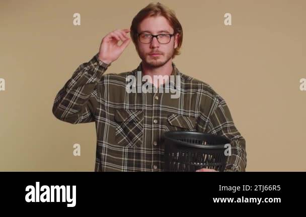 Happy man 20s in shirt taking off, throwing out glasses into bin after ...