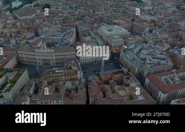 Fly above large city at sunset. Zoomed aerial footage of historic ...