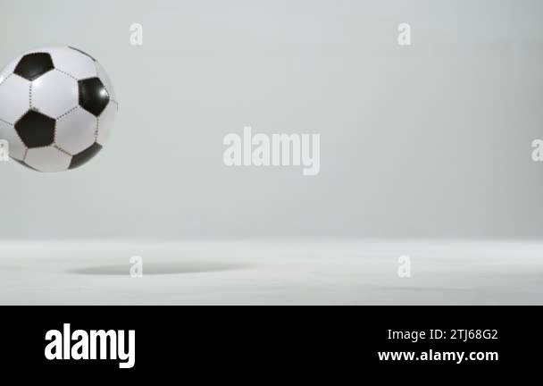 Super slow motion of rotating soccer ball on white background. Filmed ...