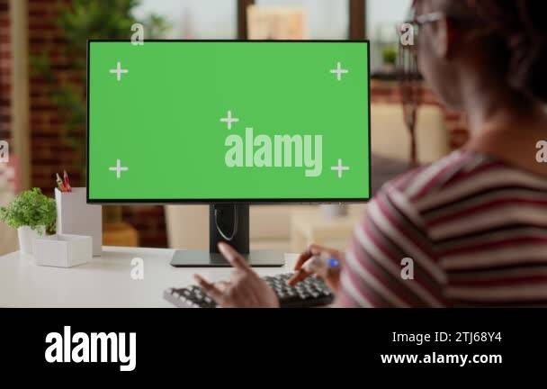 Freelancer woman working remotely with greenscreen on computer, using ...