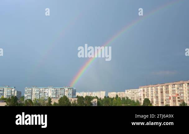Rainbow on the blue sky with urban house view. Seven colors of the ...