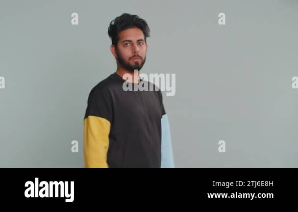 Hello. Come here, join us. Welcome. Indian man stands aside and turns ...