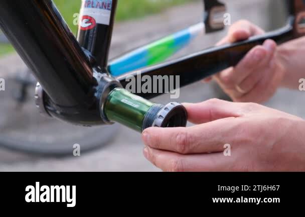 May 17, 2023Ukraine, Dnipro.Assembly master led at work. Replacing the system on a track bike ...