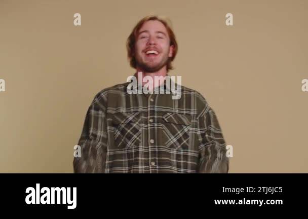 Rock n roll. Overjoyed delighted man 20 years old in shirt showing ...