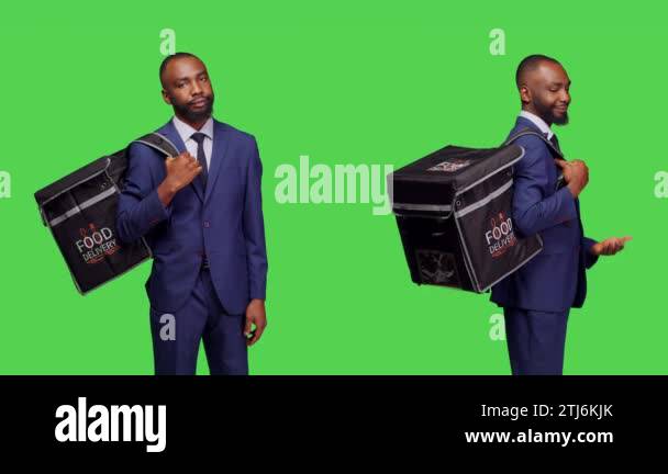 Deliveryman with formal suit carrying thermal backpack on greenscreen ...