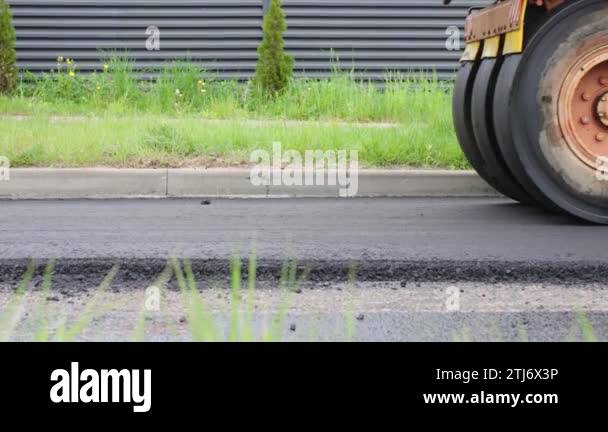 Repair surface of the road, laying a new layer of pavement on a city ...