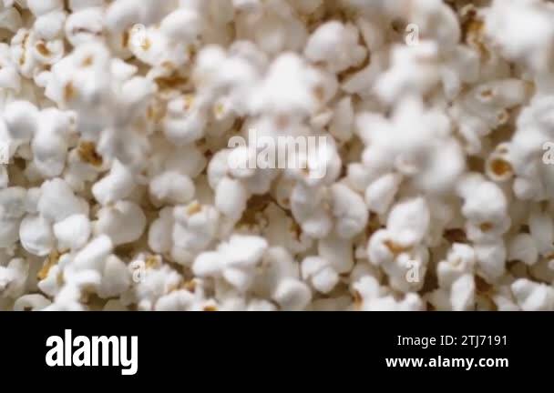 Mixing fresh hot popcorn. Close-up of popcorn production in slow motion ...