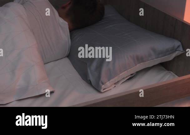 Preteen boy sleeping and tossing and turning in bed at night in his ...