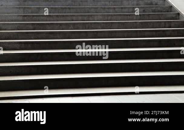 Closeup isolated legs of pedestrians descending the steps in the subway ...
