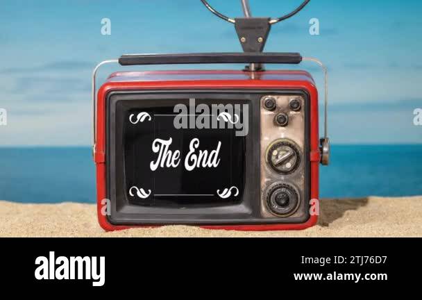 A vintage television on the beach with old fashioned cinema titles ...
