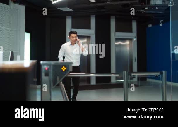 Man worker walks through a Automatic security turnstile station in ...