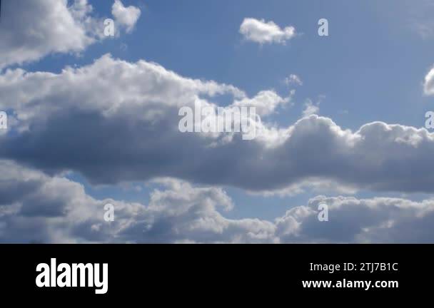 Blue sky and white clouds. Puffy fluffy white clouds. Cumulus cloud cloudscape timelapse. Summer ...