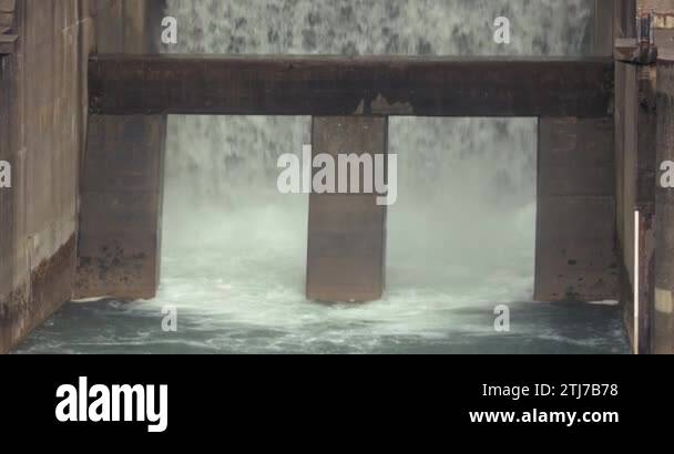 Hydroelectric powerplant with water splashing under the dam spillway on ...