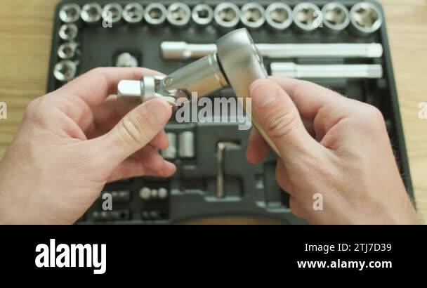 Mechanic disconnects the adapter from the ratchet and puts everything ...