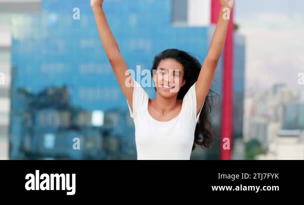 Young black woman raising arms in the air expressing victory feeling ...