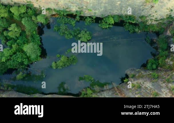 Green trees grow in water of abandoned quarry Little America on summer ...