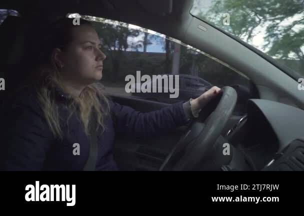 Sad, tense, focused, angry, nervous, young, beautiful woman driving car ...