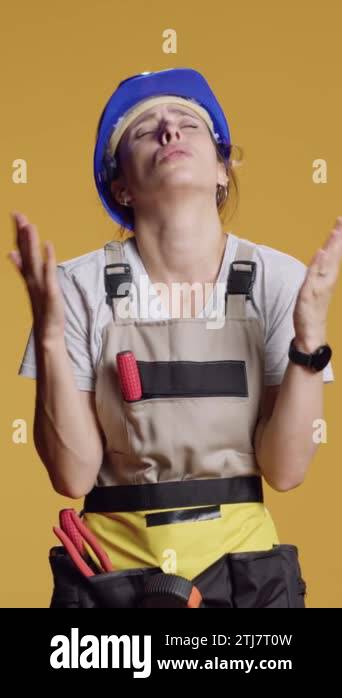 Portrait of construction worker doing prayer hands gesture, wishing to ...