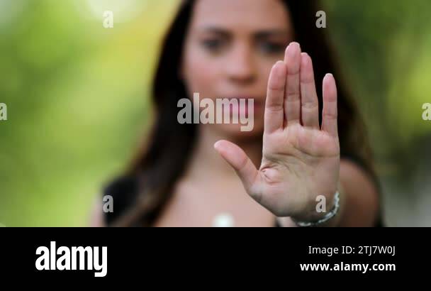 Woman annoyed making stop sign with hand, saying no, expressing defense ...