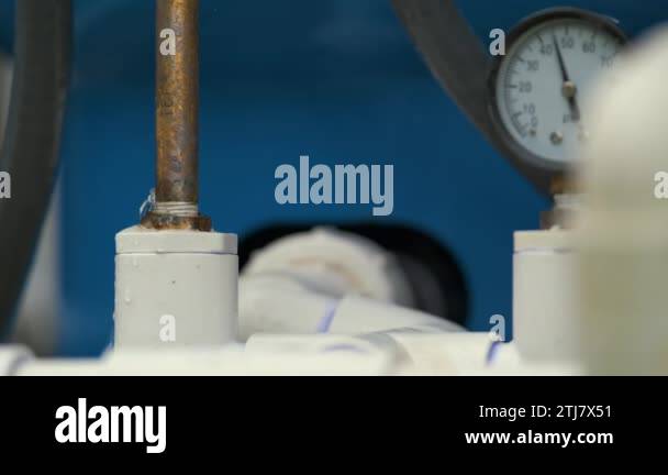 Plastic pipes leaking water out of defective connection of outdoor ...