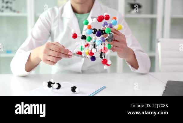 Scientist looks at model of molecular structure. Molecule definition ...