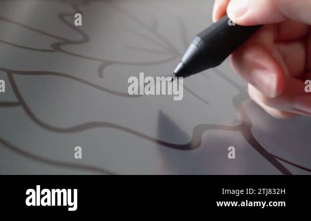 Woman's hand holding a pen stylus making an illustration using a ...