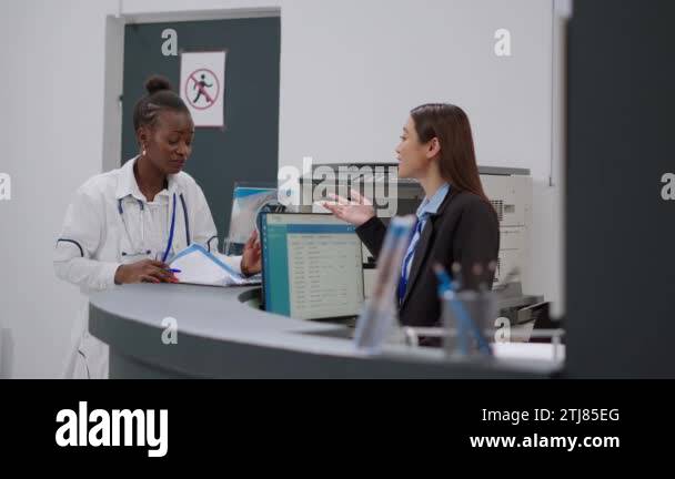 Diverse medical team talking about healthcare appointments and ...