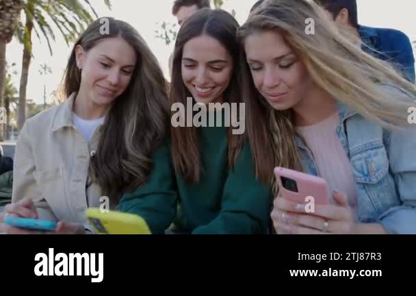 Young group of pretty women having fun using smart mobile phones ...