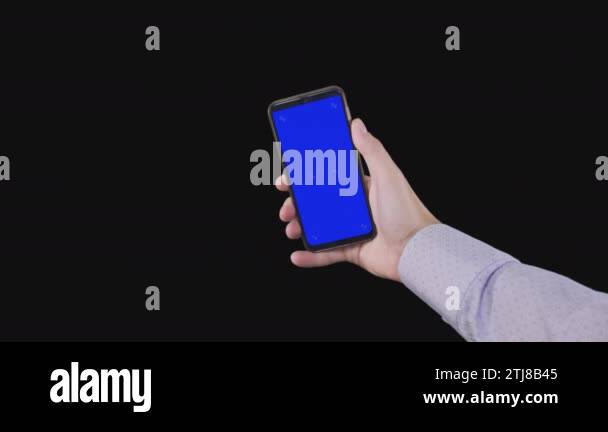 Male hand holding a smartphone with a blue screen with markers on alpha ...
