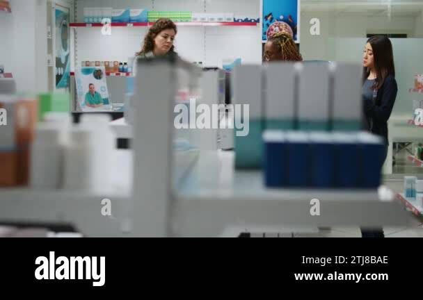 Multiethnic Group Of People Buying Pills And Supplements From Drugstore Desk Using Smartwatch