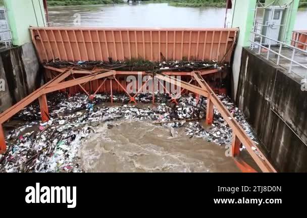 Aerial view of turbid brown forest water released by concrete dam ...