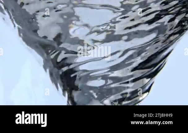 Cold gin making funnel inside container closeup. Transparent tonic ...