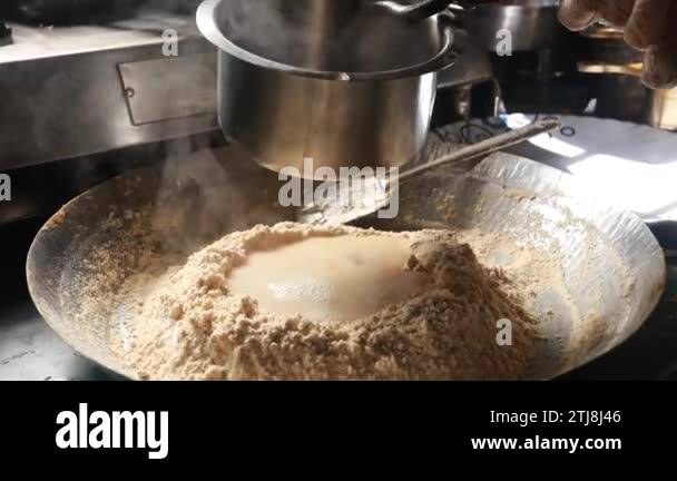Add boiling water in a flour for chakkali dough. Indian Traditional ...
