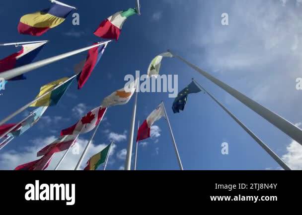 Flags of the World waving in the wind on a background blue sky and ...