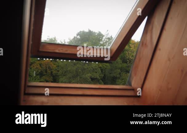Raindrops falling from open window frame. Open window with view of ...