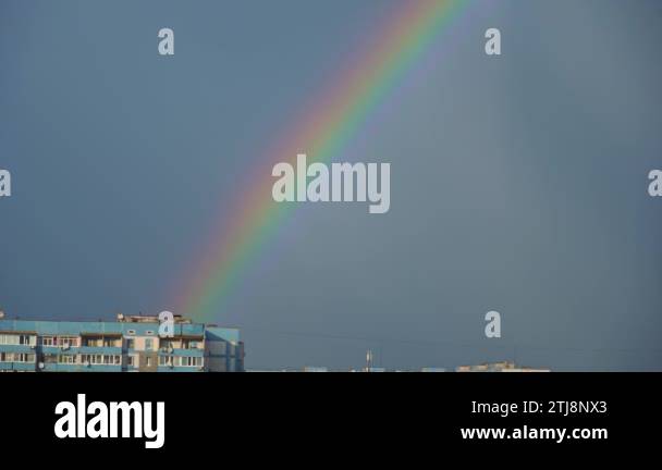 Rainbow on the blue sky with urban house view. Seven colors of the ...