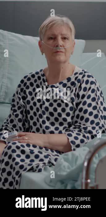 Vertical video: Portrait of elder patient with illness looking at ...